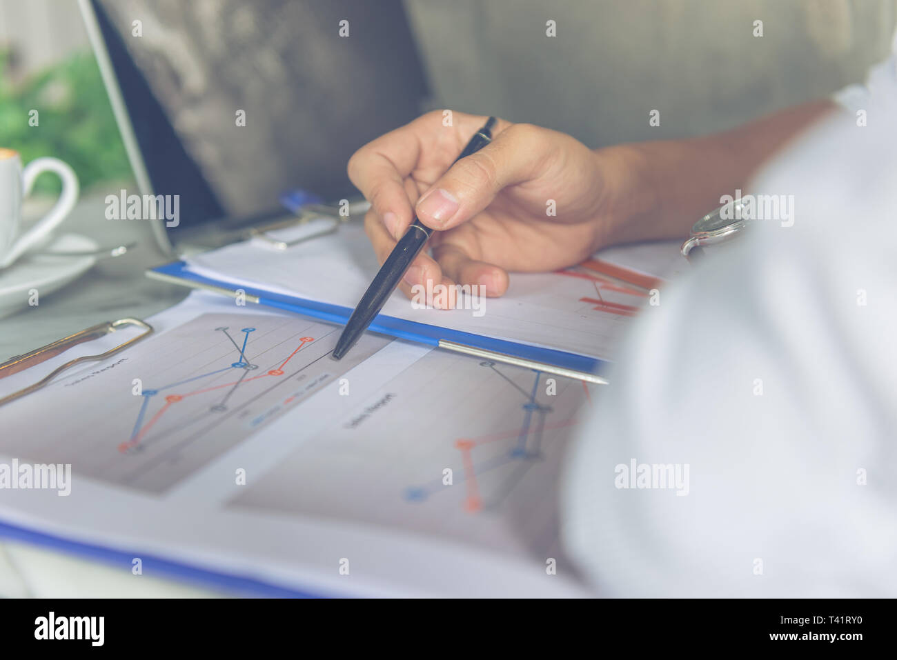 Man checking financial report document in the office Stock Photo - Alamy
