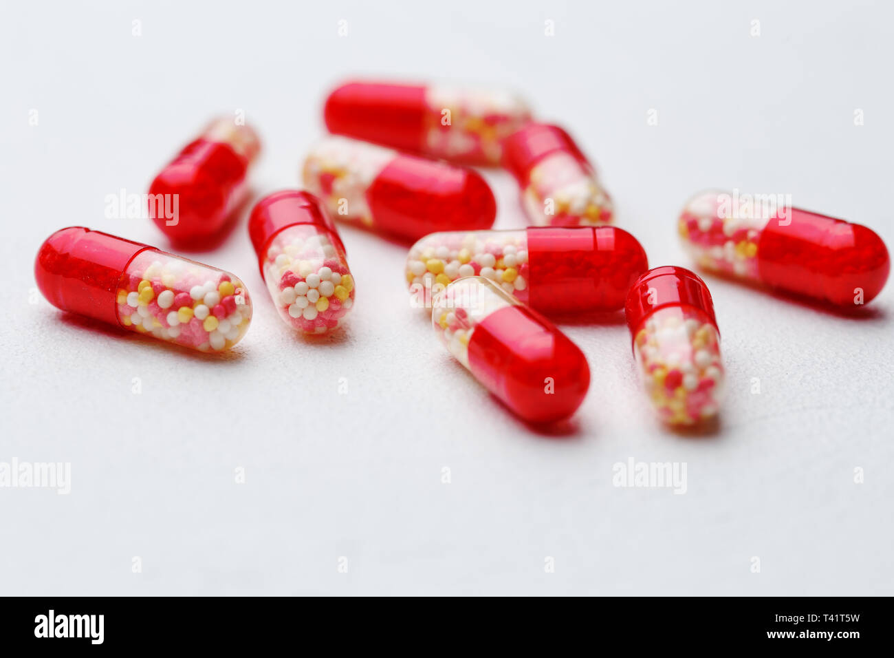 Pharmaceutical medicine capsules over white background Stock Photo - Alamy