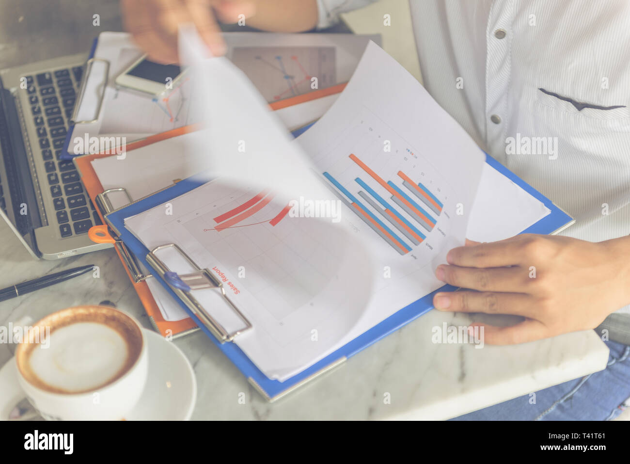 Young office employee reading financial report document Stock Photo - Alamy
