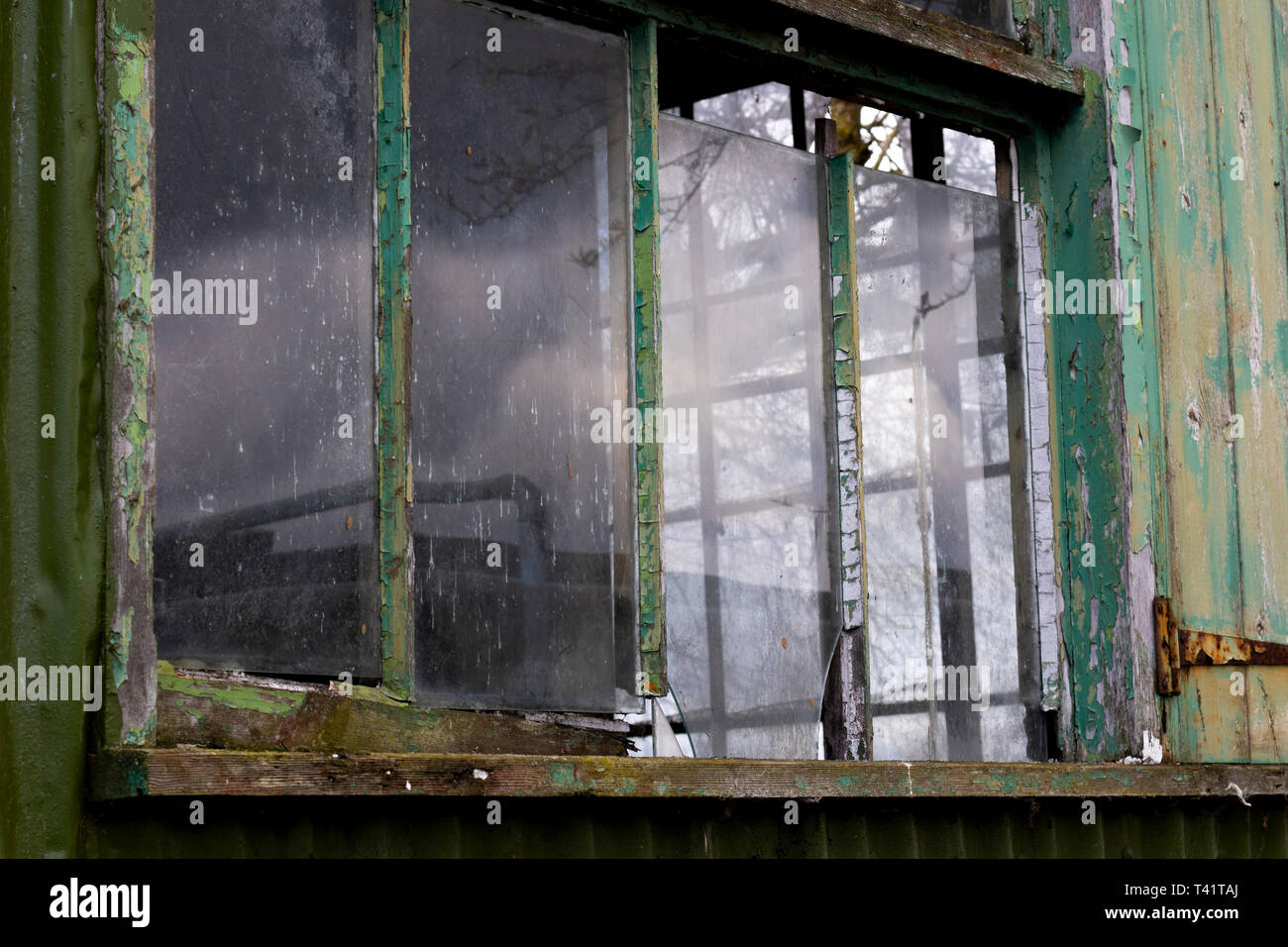 Dilapidated wooden window frame on condemned derelict factory building ...