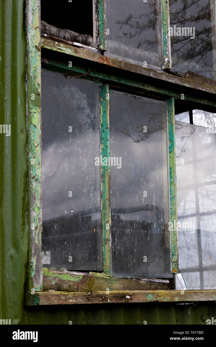 Dilapidated wooden window frame on condemned derelict factory building ...