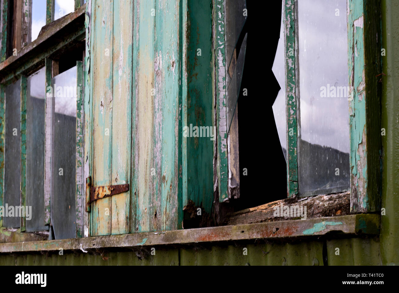 Dilapidated wooden window frame on condemned derelict factory building ...