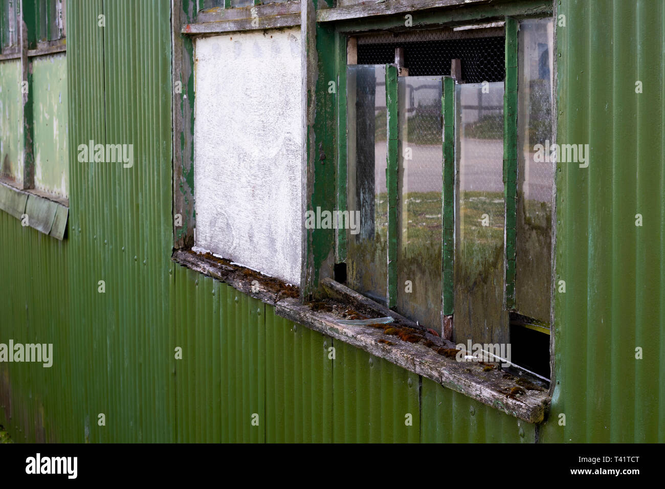 Dilapidated wooden window frame on condemned derelict factory building ...