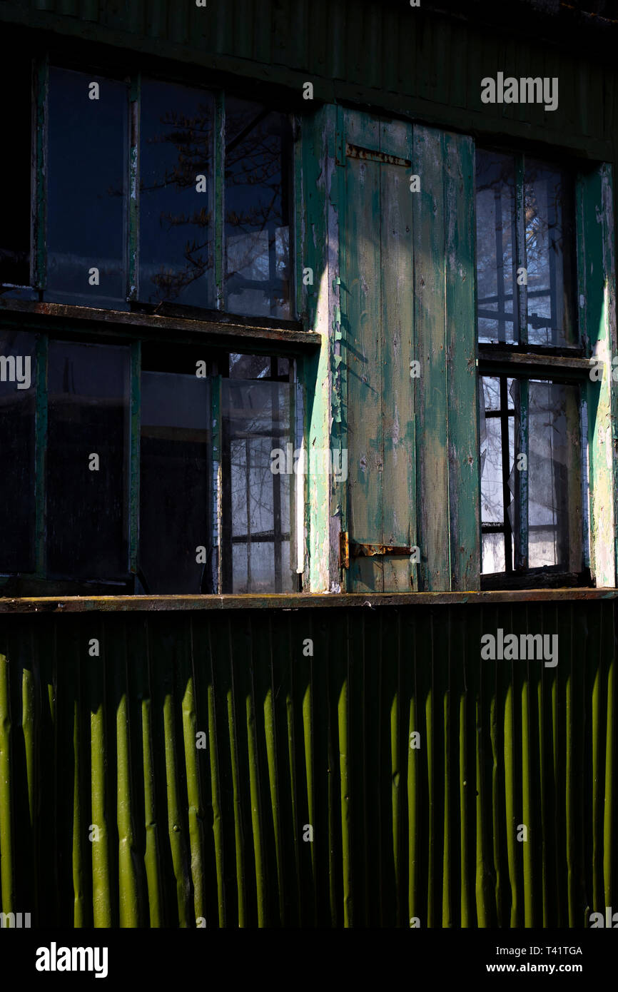Dilapidated wooden window frame on condemned derelict factory building ...