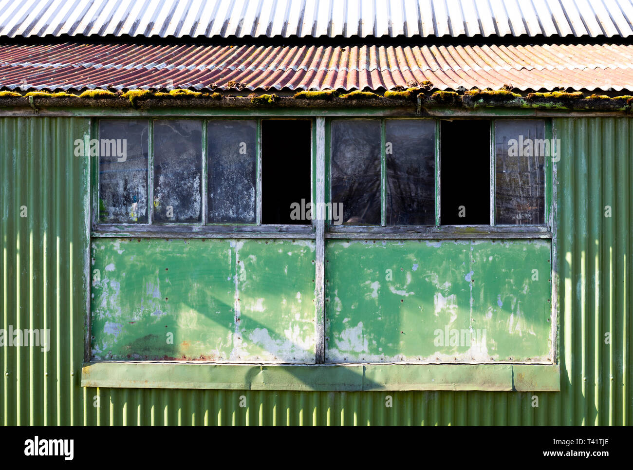 Dilapidated wooden window frame on condemned derelict factory building ...