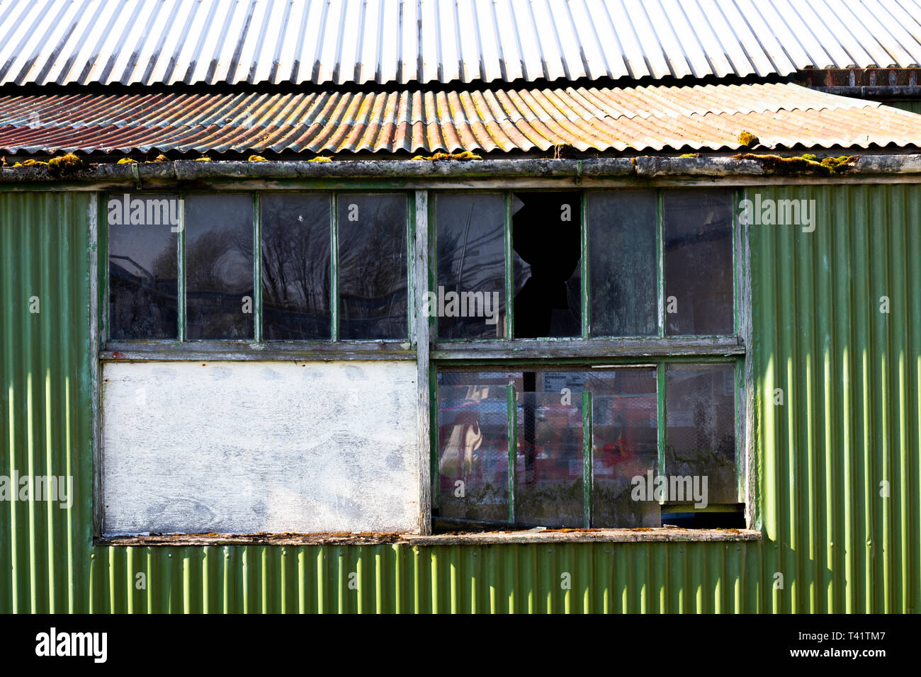 Dilapidated wooden window frame on condemned derelict factory building ...
