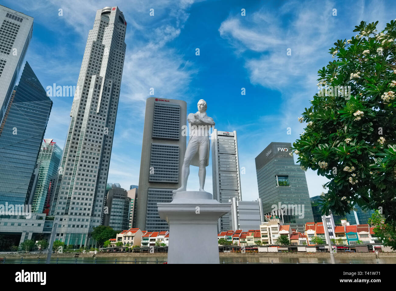 The statue of Sir Stamford Raffles at Raffles Landing Site, Boat Quay, Singapore, the buildings ...
