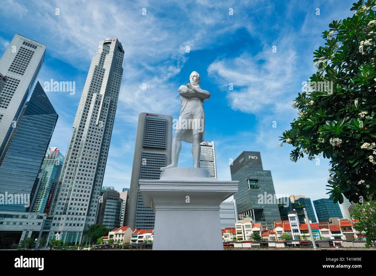 The statue of Sir Stamford Raffles at Raffles Landing Site, Boat Quay, Singapore, the buildings ...