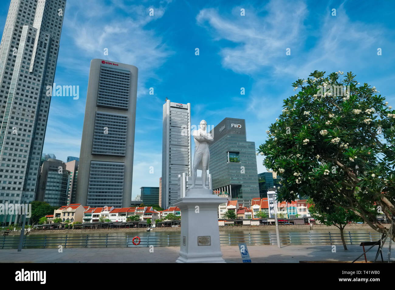 The statue of Sir Stamford Raffles at Raffles Landing Site, Boat Quay, Singapore, the buildings ...