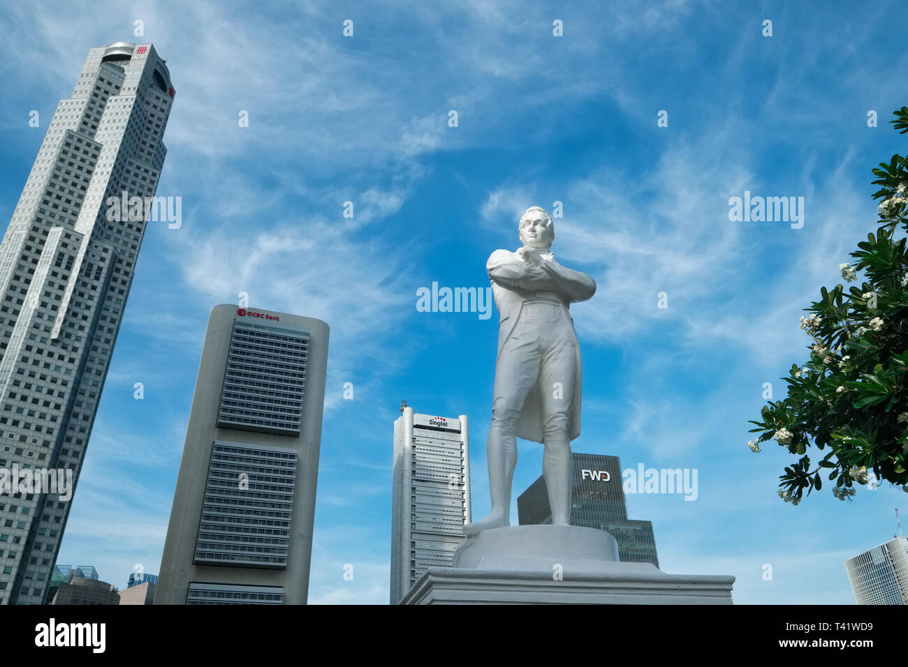 The statue of Sir Stamford Raffles at Raffles Landing Site, Boat Quay, Singapore, the buildings ...