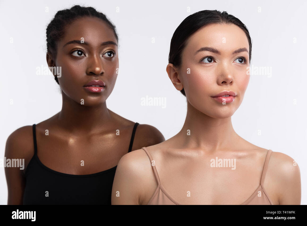 Different but same. Beautiful young women with hair buns having ...