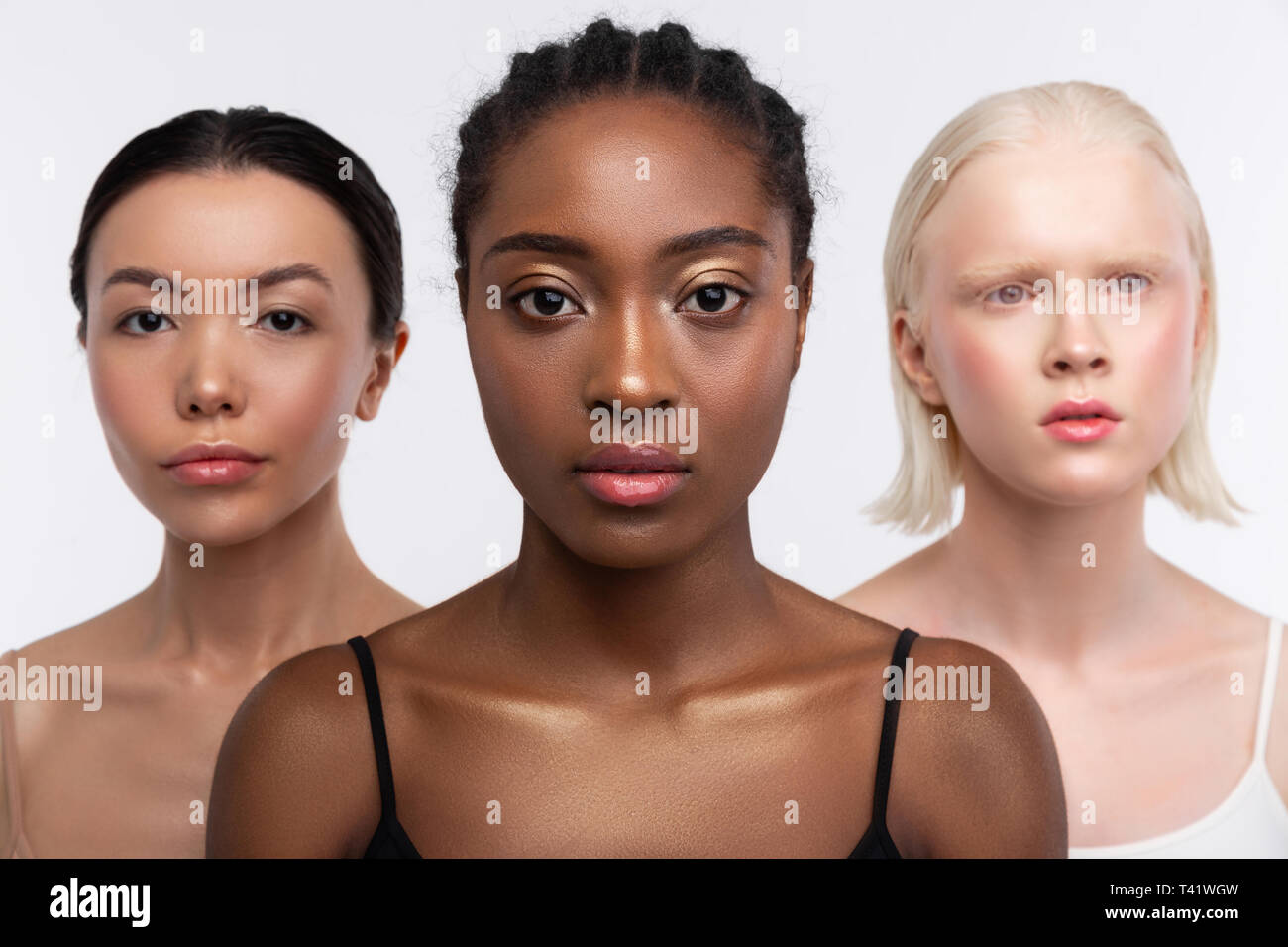 Different complexion. Three young appealing women with different ...