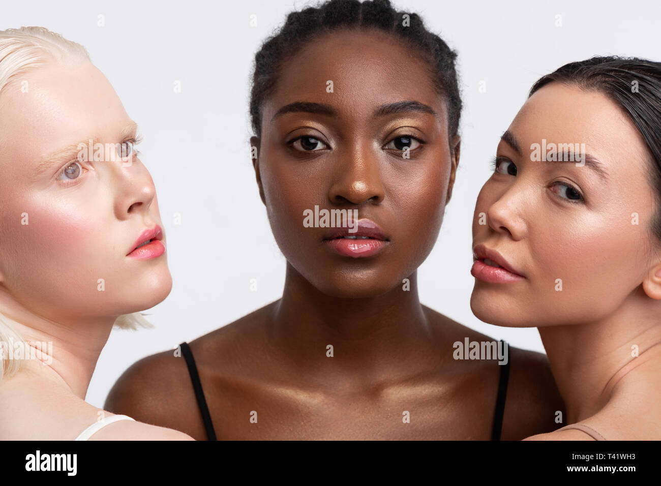 Standing between. Dark-eyed beautiful African-American woman standing ...