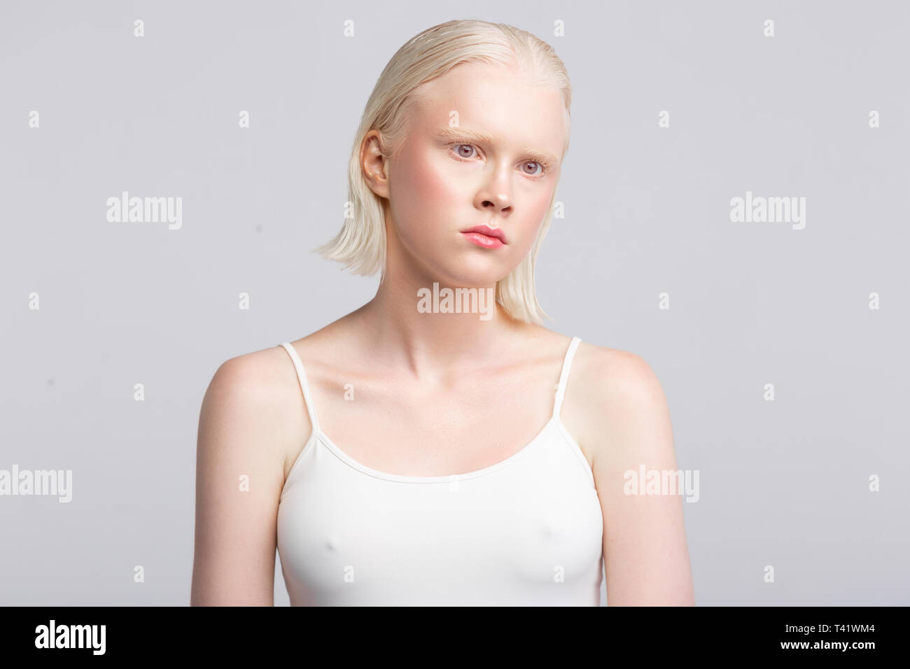 Strange face. Grey-eyed women with white skin wearing white camisole ...