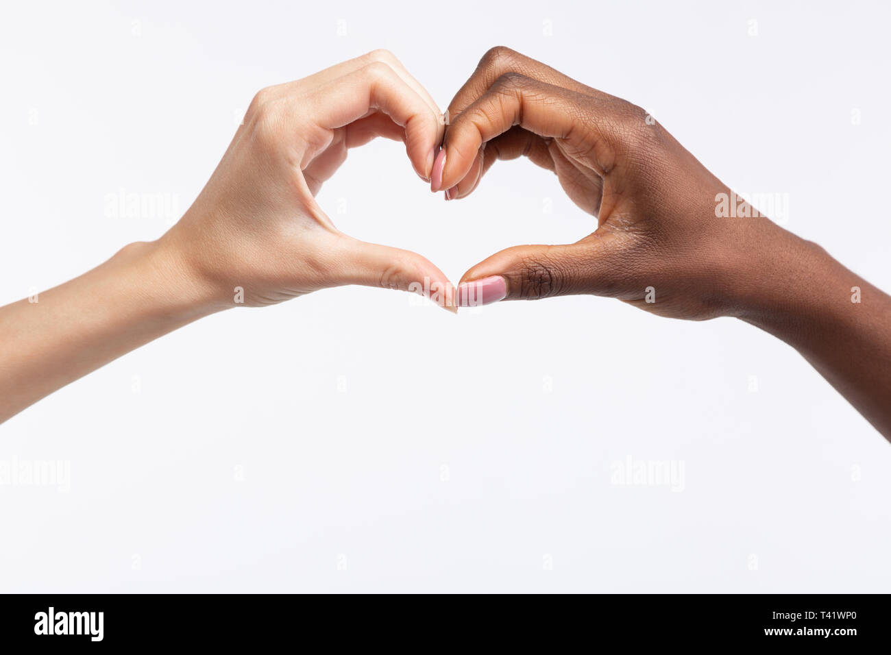 Women with different skin color making heart out of hands Stock Photo ...