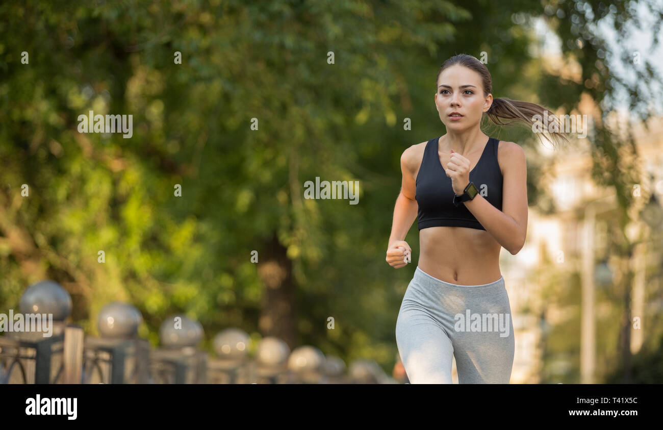 Motivated millennial woman running forward to goal Stock Photo - Alamy Motivated millennial woman running forward to goal Stock Photo - Alamy