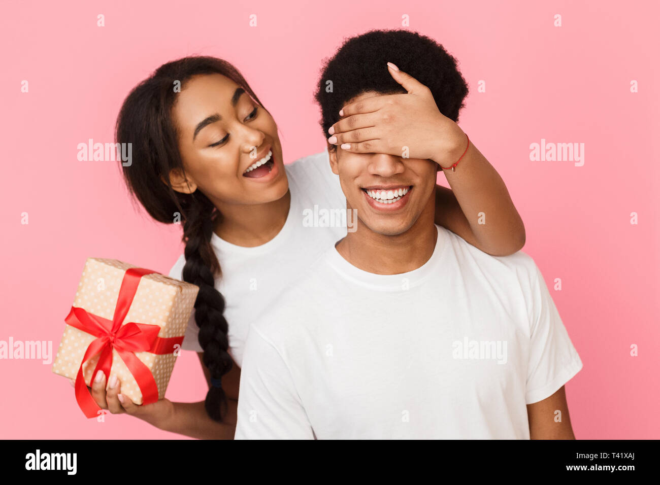 Surprise for you. Girl covering boyfriend eyes Stock Photo - Alamy