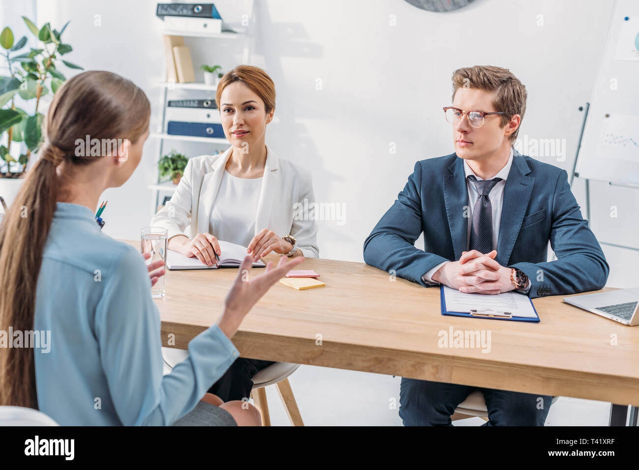 back view of woman speaking with recruiters during job interview Stock ...