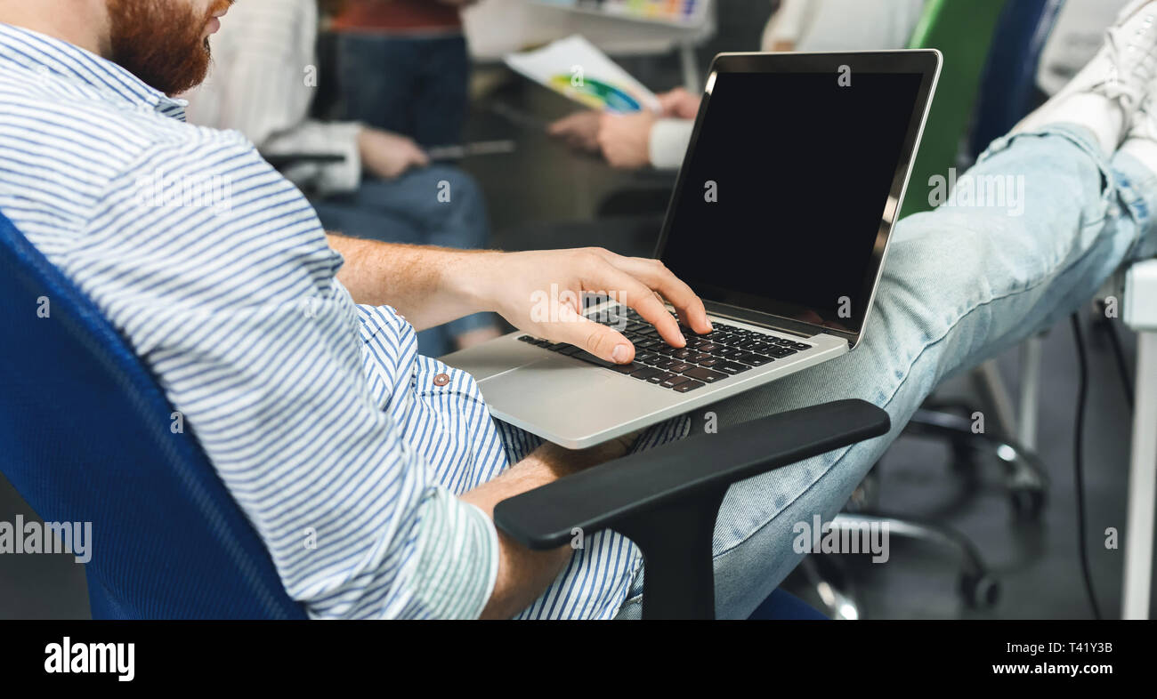 Self-employed entrepreneur working on laptop with blank screen Stock ...