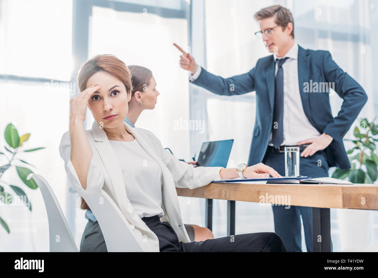 attractive recruiter looking at camera while man in glasses talking and ...