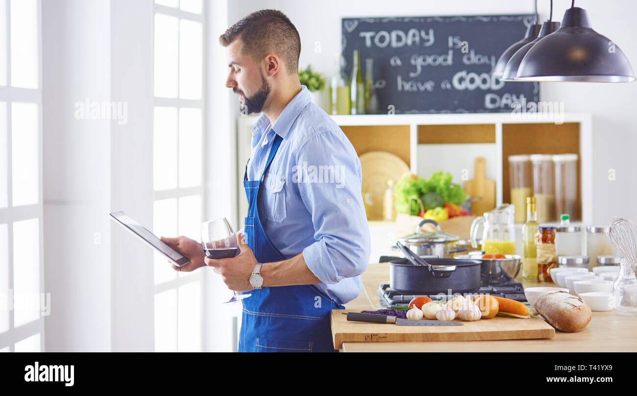 cook with a tablet in hand and studying the recipe Stock Photo - Alamy