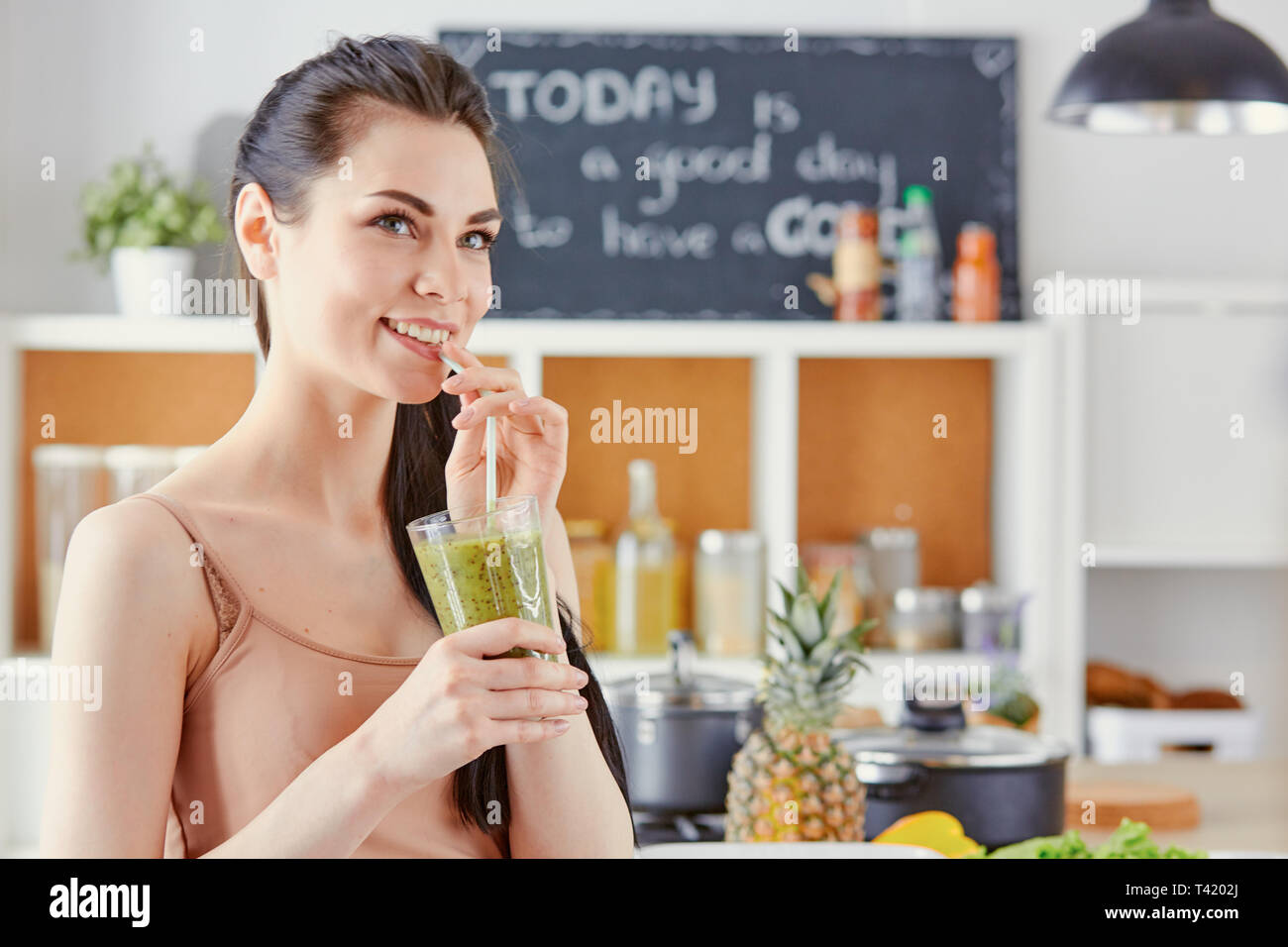 a young girl drinks a cocktail on a kitchen Stock Photo - Alamy