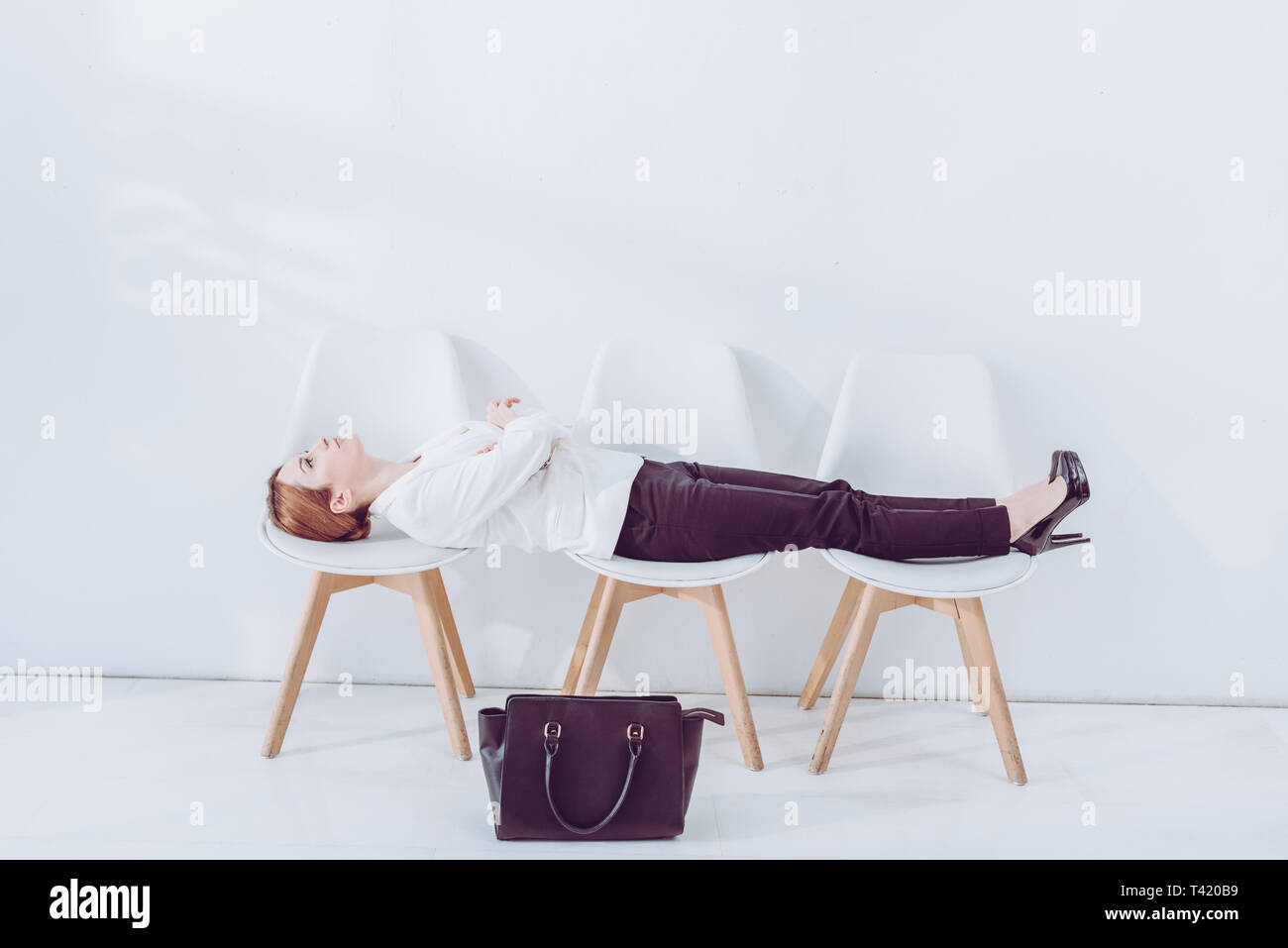 attractive employee lying on chairs while waiting job interview Stock ...