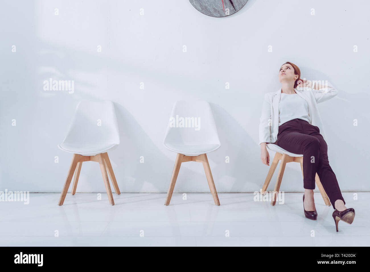 attractive employee sitting on chair and waiting job interview Stock ...