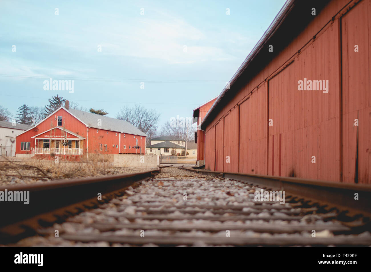 Train Tracks with red barns in a small town Stock Photo - Alamy