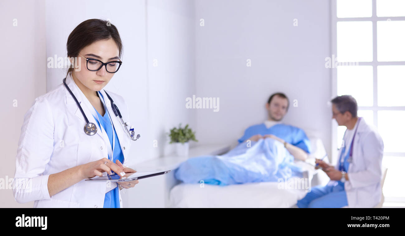 Doctor checking heart beat of patient in bed with stethoscope Stock ...