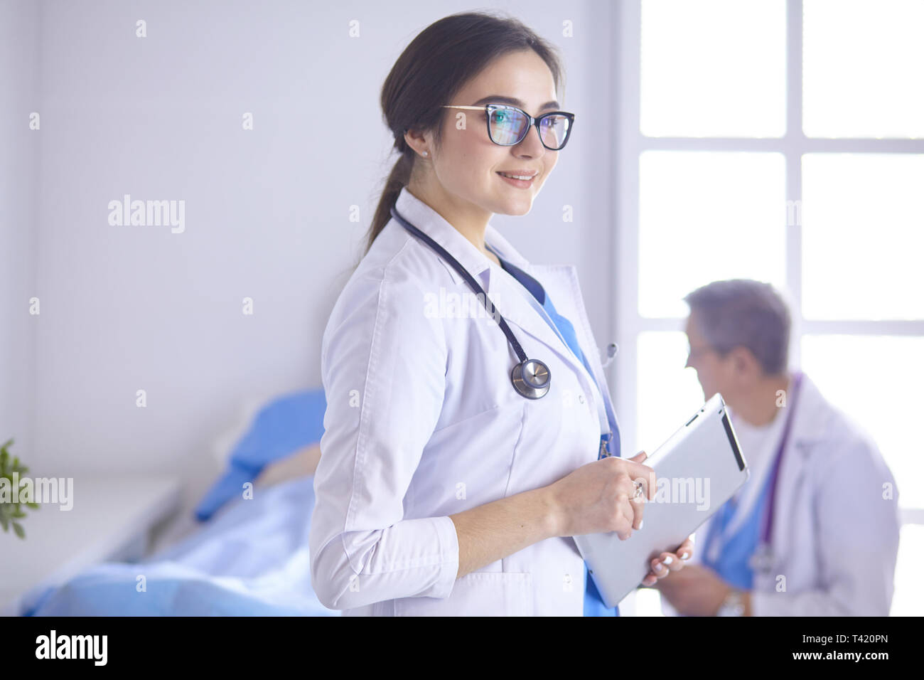 Doctor checking heart beat of patient in bed with stethoscope Stock ...
