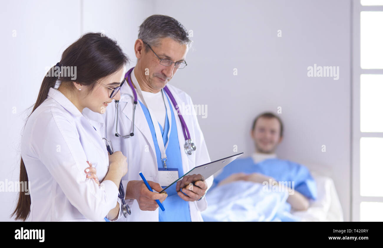Doctor checking heart beat of patient in bed with stethoscope Stock ...