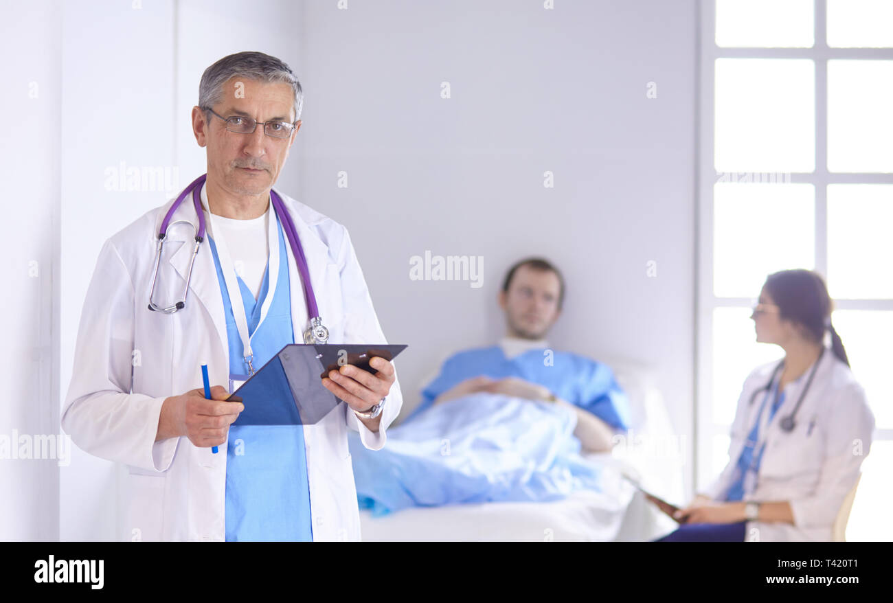 Doctor checking heart beat of patient in bed with stethoscope Stock ...