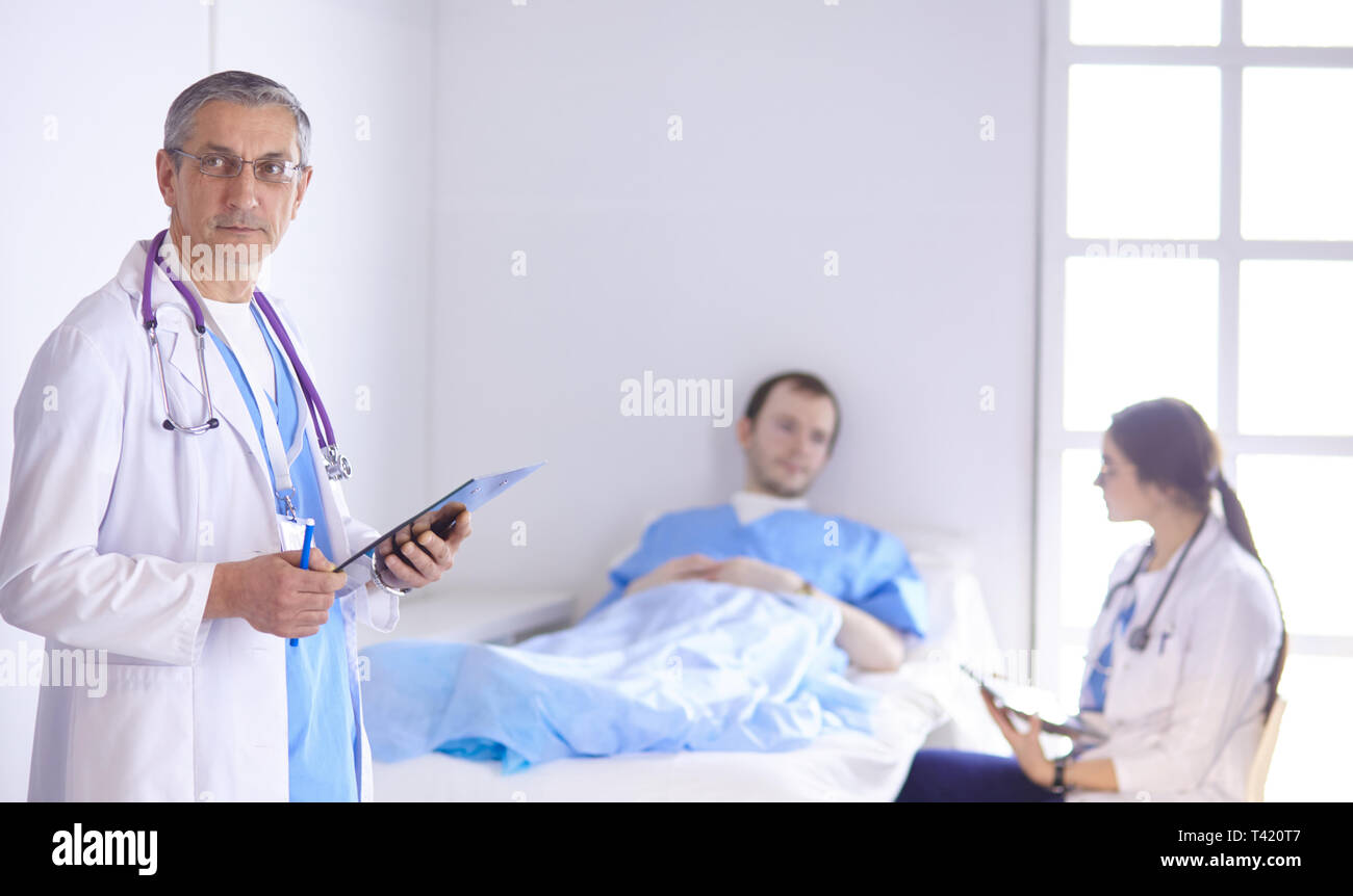 Doctor checking heart beat of patient in bed with stethoscope Stock ...