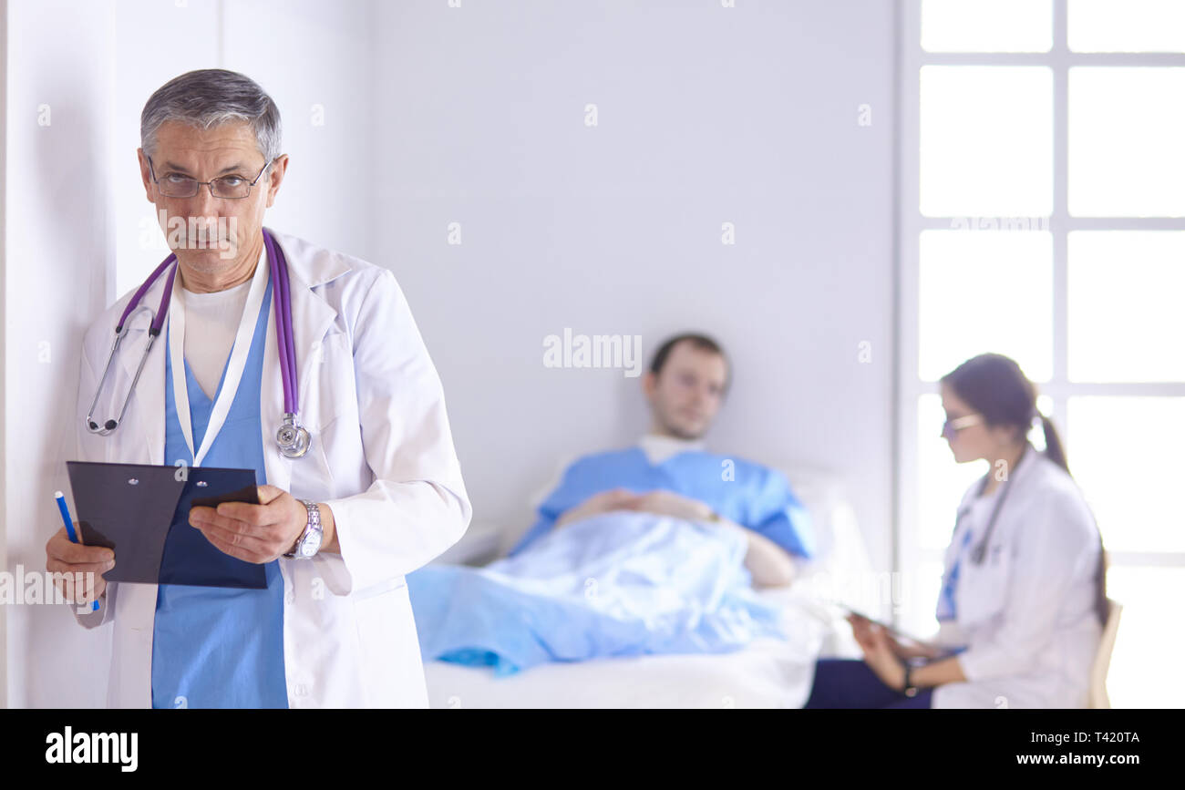 Doctor checking heart beat of patient in bed with stethoscope Stock ...