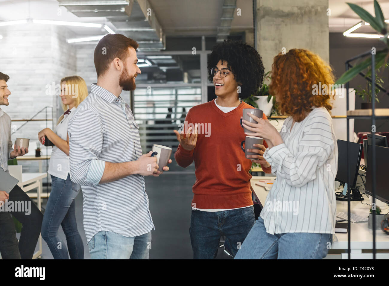 Diverse millennials enjoying communication in modern office Stock Photo ...