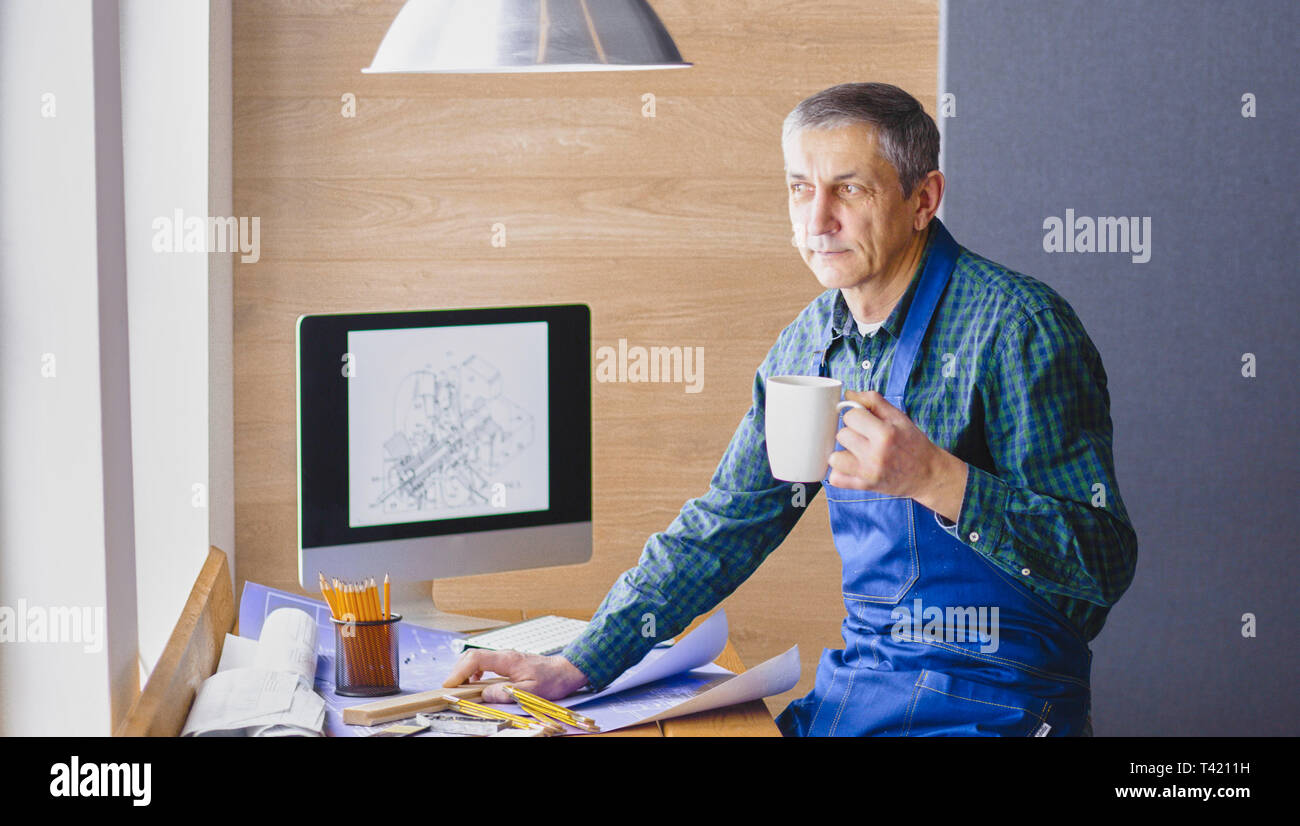Engineer carpenter working on laptop and sketching project Stock Photo ...