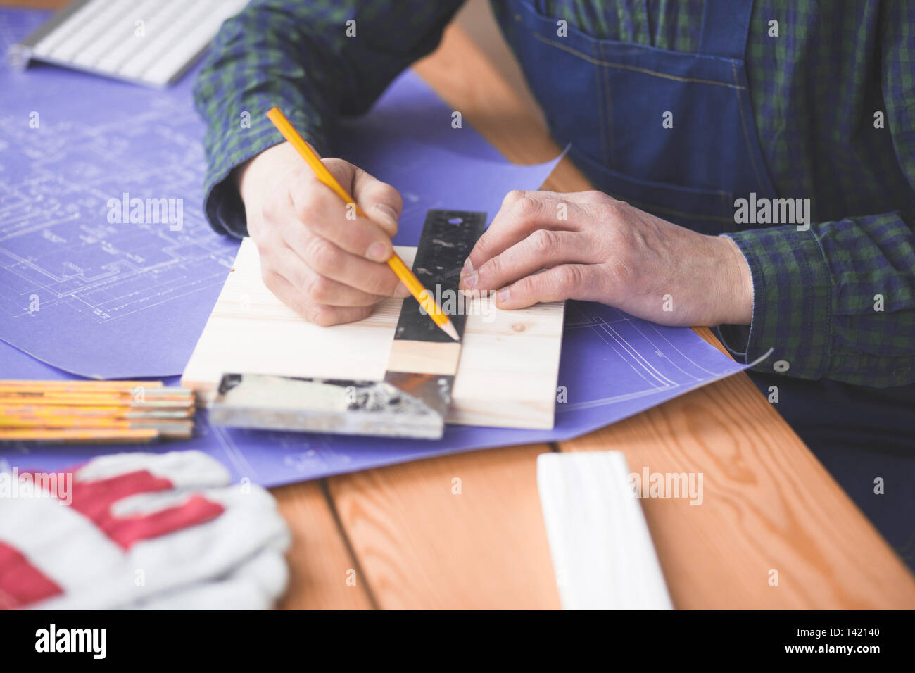 Engineer carpenter working on laptop and sketching project Stock Photo ...