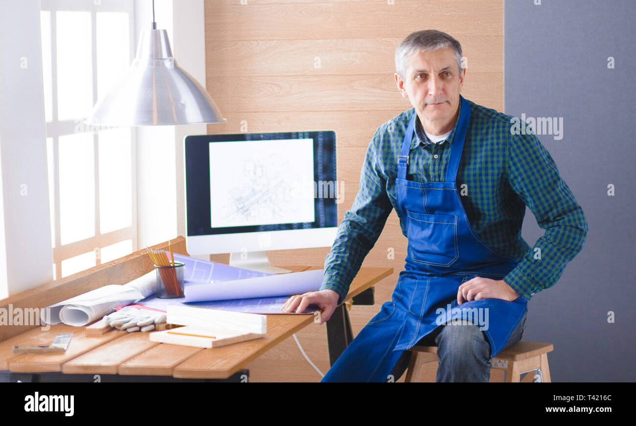 Engineer carpenter working on laptop and sketching project Stock Photo ...