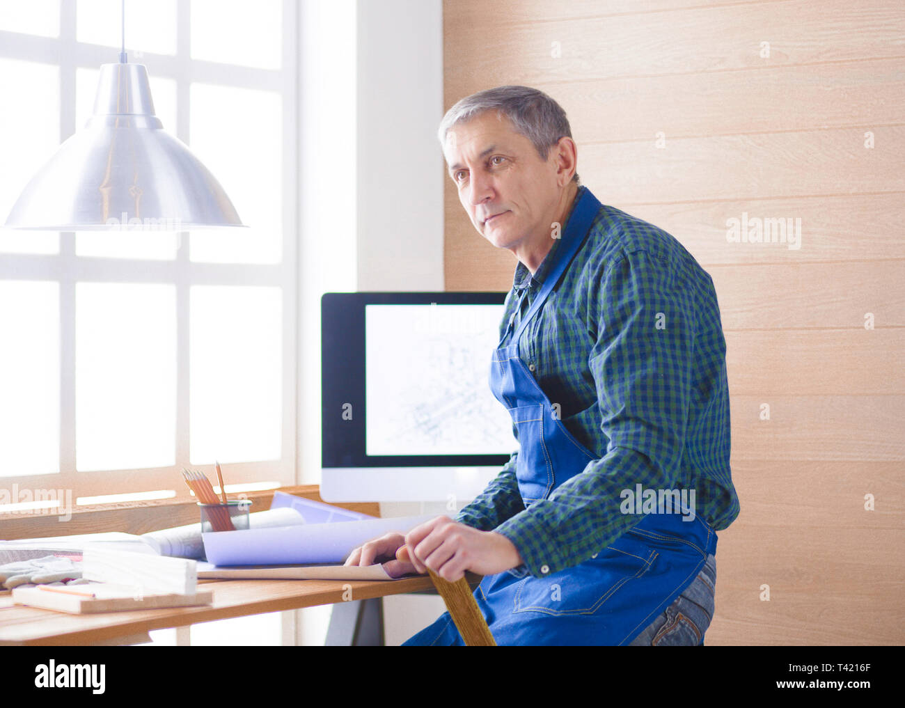 Engineer carpenter working on laptop and sketching project Stock Photo ...