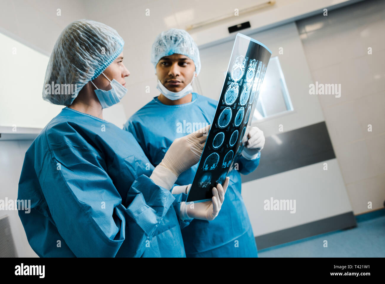 good-looking and beautiful doctors in uniforms and medical masks ...