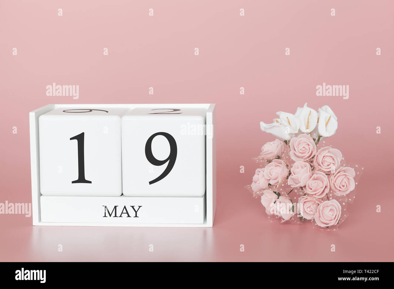 May 19th. Day 19 of month. Calendar cube on modern pink background ...
