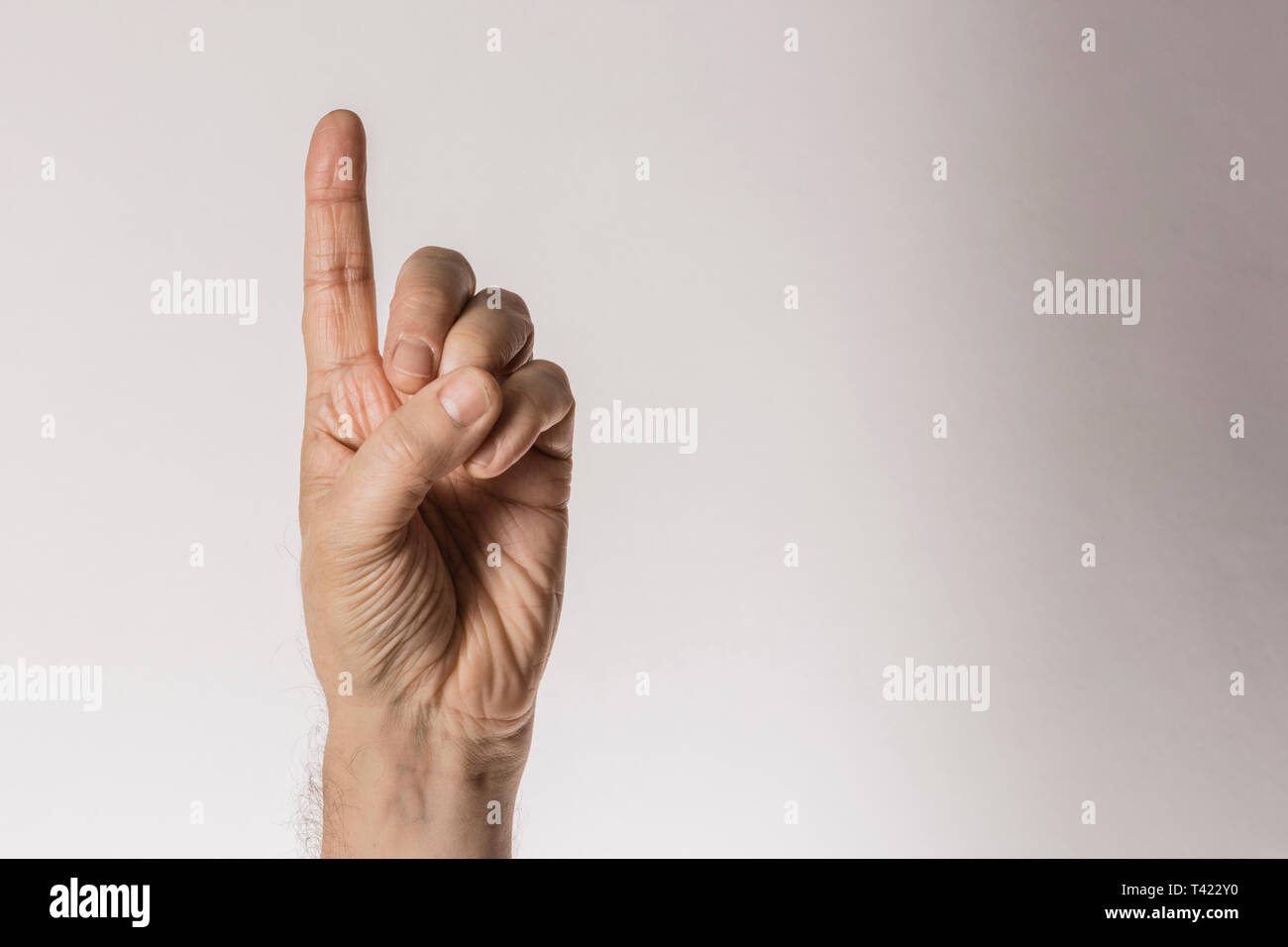 Man`s hand gesture, counting number one, isolated on white background ...