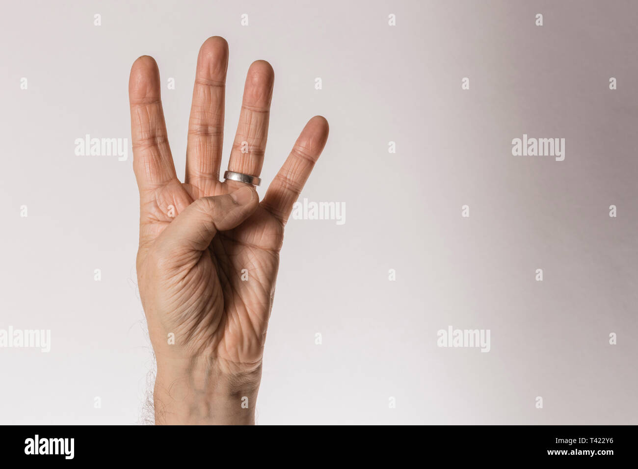 Man`s hand gesture, counting number four, isolated on white background ...