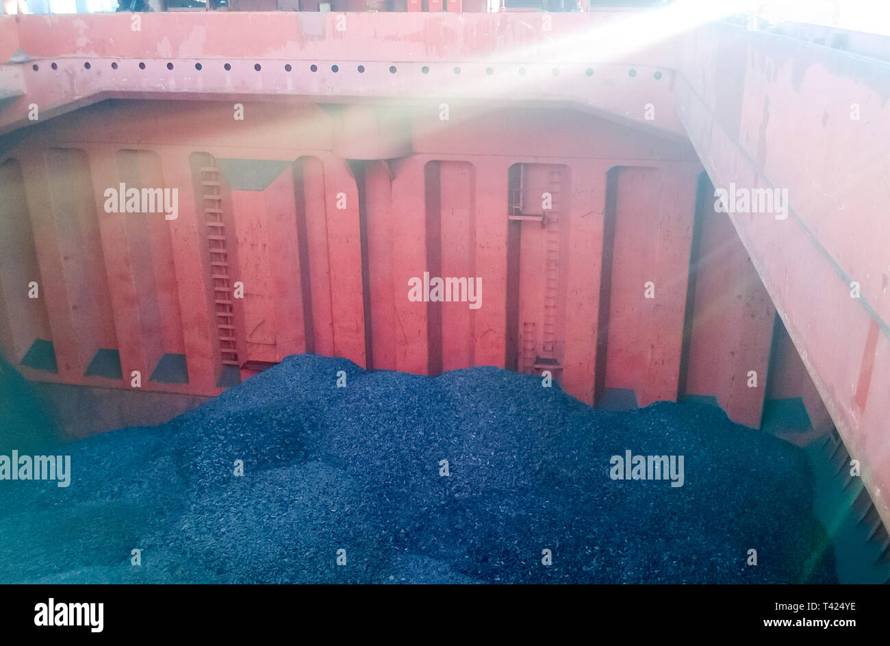 The cargo compartment of the ship, filled with coal. Loading of ...