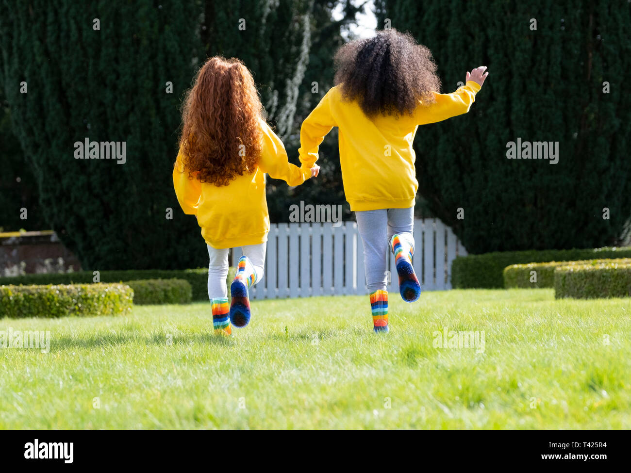 Children skipping enjoying playing outside Stock Photo - Alamy