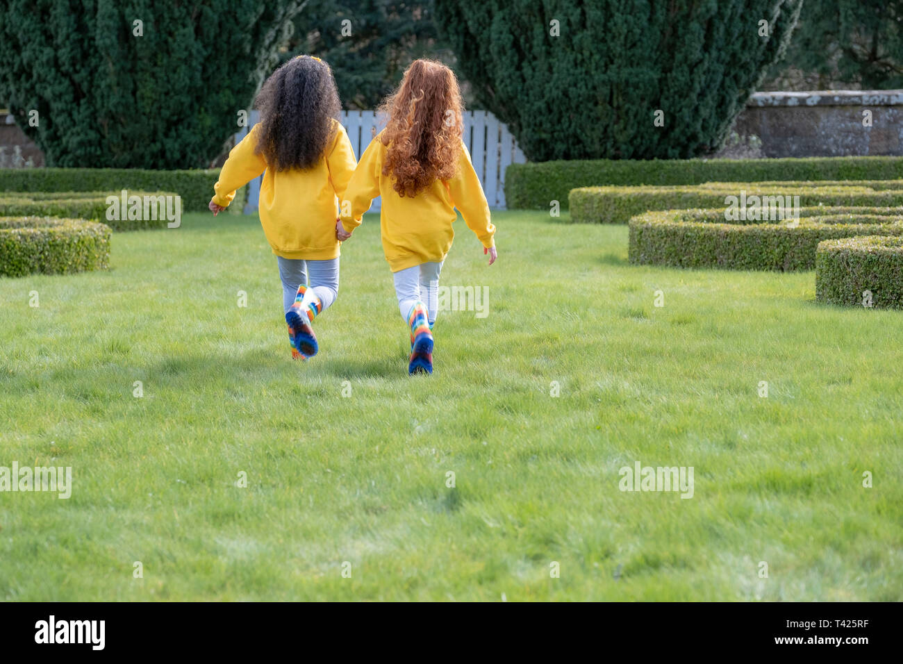 Children skipping enjoying playing outside hi-res stock photography and ...