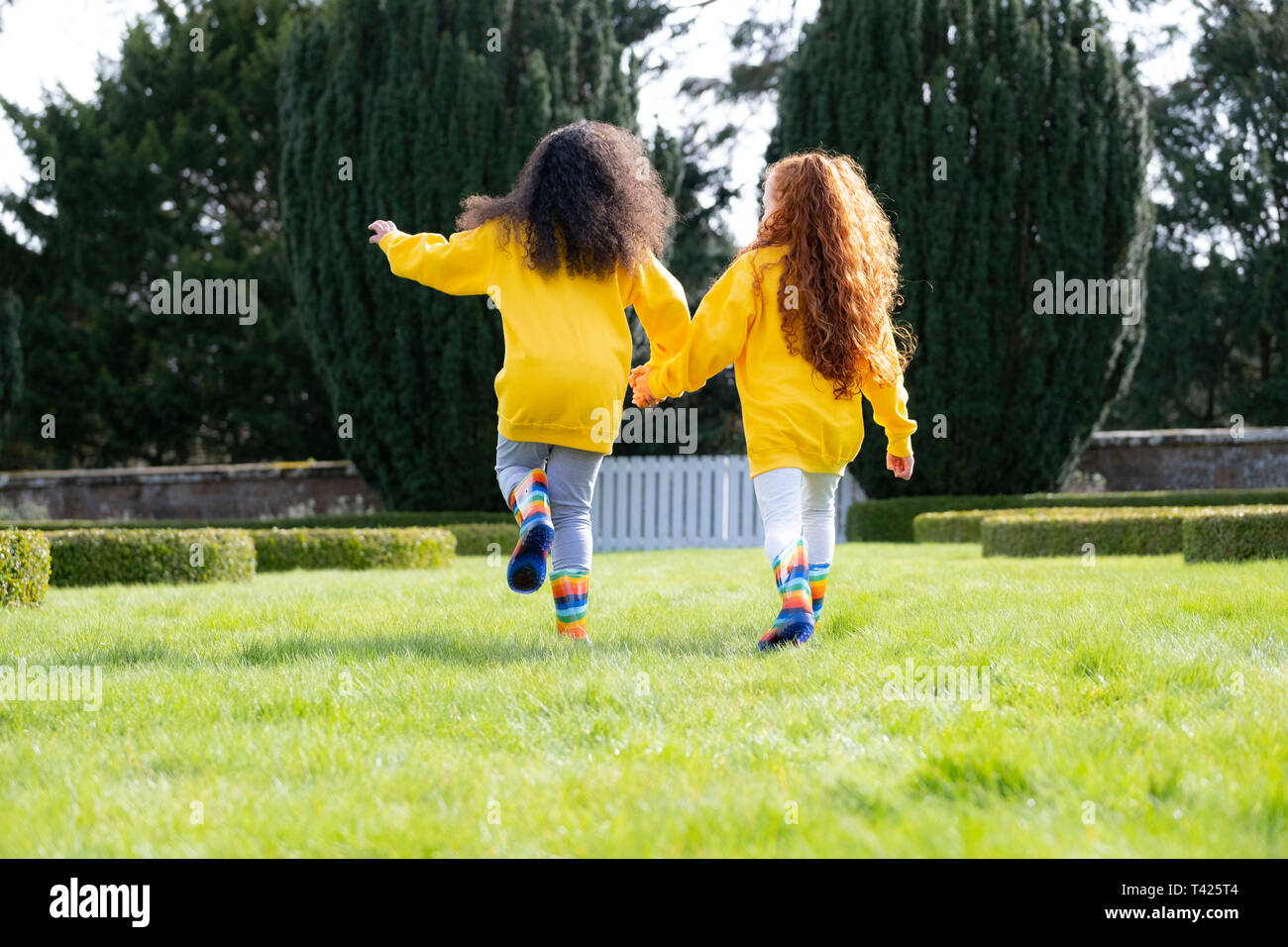 Children skipping enjoying playing outside Stock Photo - Alamy