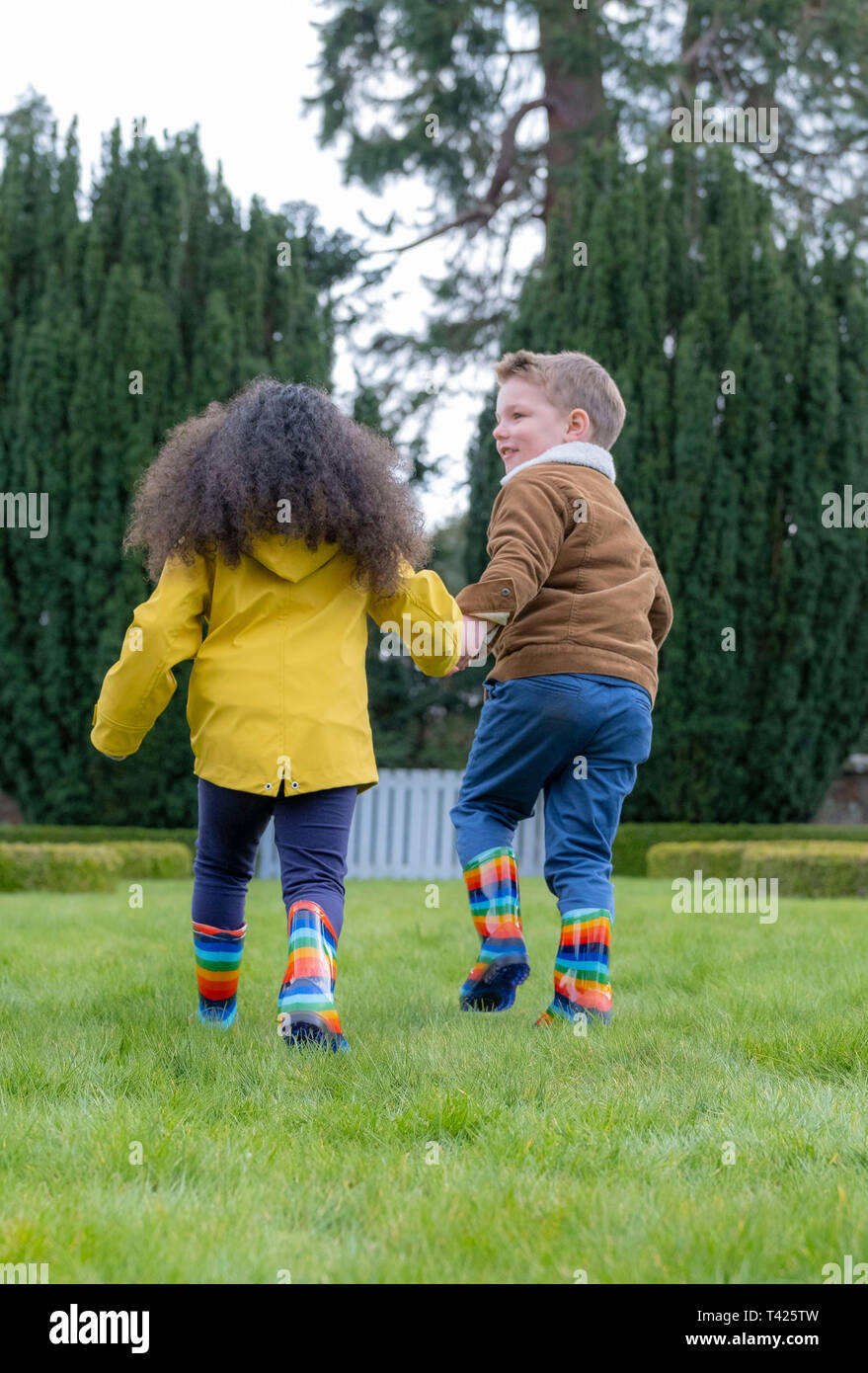 Children skipping enjoying playing outside Stock Photo - Alamy