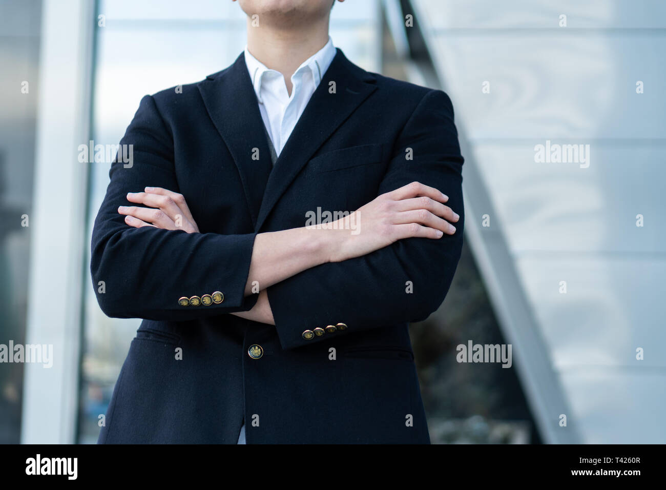 Young man suit grey arms folded hi-res stock photography and images - Alamy